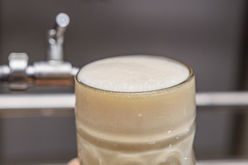 Frothy Beer in a Glass Mug with Foam Overflowing Stock Image - Image of ...
