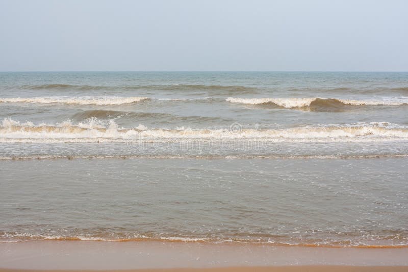 Frothy waves on beach stock image. Image of copyspace - 79640797