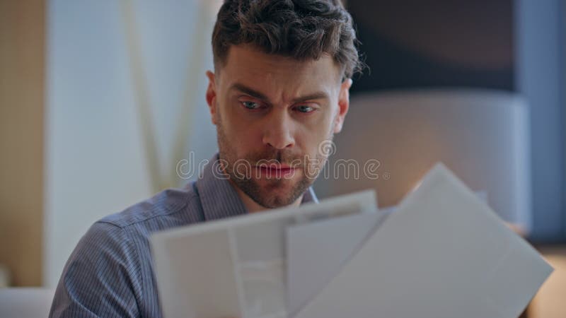 Frowning Designer Examining Sketches at Modern Workspace Closeup ...