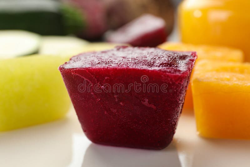 Frozen Beet, Pumpkin and Zucchini Puree Cubes on Plate, Closeup Stock ...