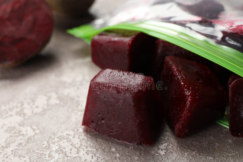 Frozen Beet Puree Cubes in Plastic Bag on Marble Table, Closeup Stock ...