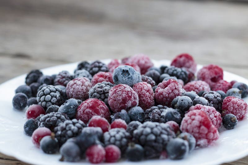 Frozen berries in a bowl, stock image. Image of blackberry - 269411671