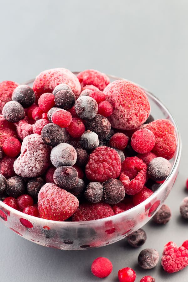 Frozen Berries in Glass Bowl and on Table, Raspberry, Strawberry ...