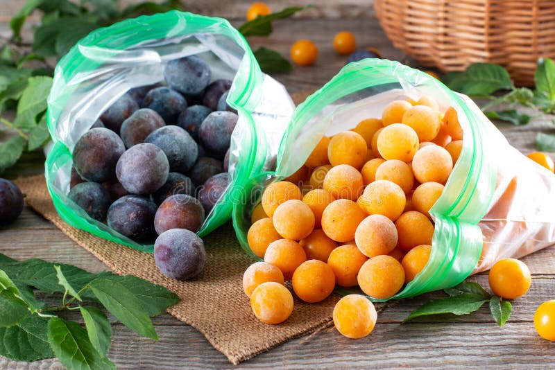 Frozen Berries on the Table. Frozen Plums, Cherry Plums in Bags and ...