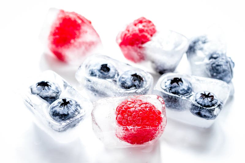 Frozen Blueberry and Raspberry in Ice Cubes on White Background Stock ...