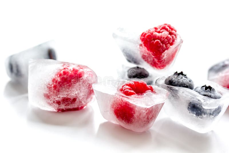 Frozen Blueberry and Raspberry in Ice Cubes on White Background Stock ...