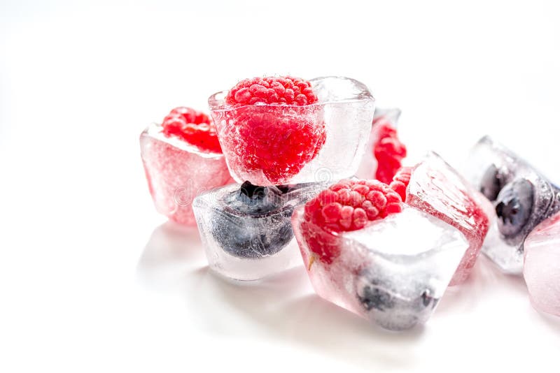 Frozen Blueberry and Raspberry in Ice Cubes on White Background Stock ...