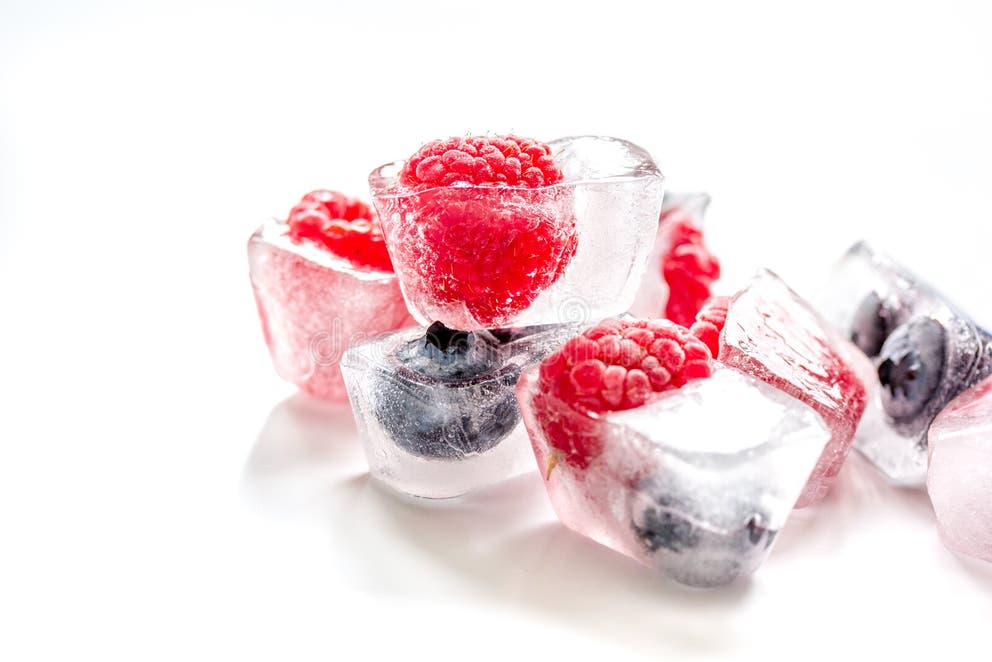 Frozen Blueberry and Raspberry in Ice Cubes on White Background Stock ...