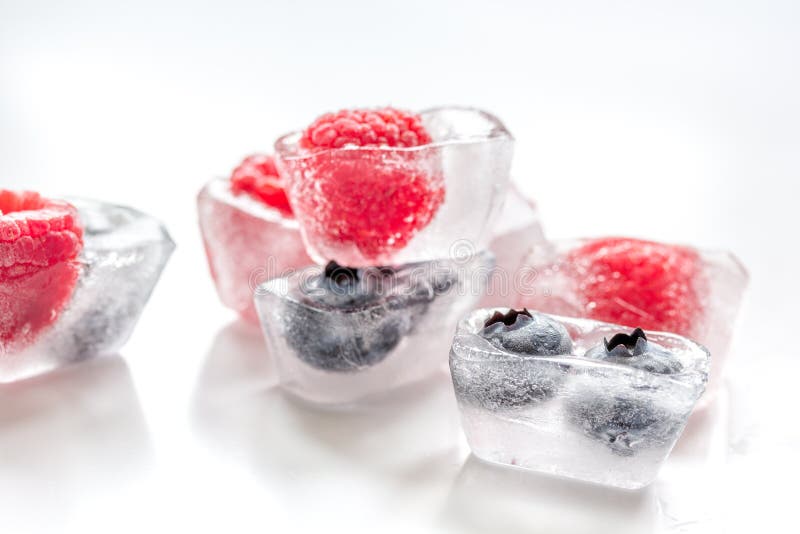 Frozen Blueberry and Raspberry in Ice Cubes on White Background Stock ...