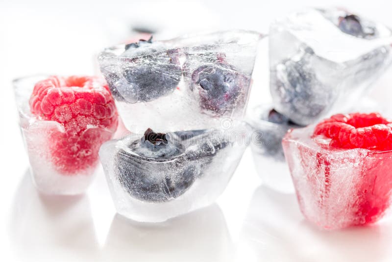 Frozen Blueberry and Raspberry in Ice Cubes on White Background Stock ...