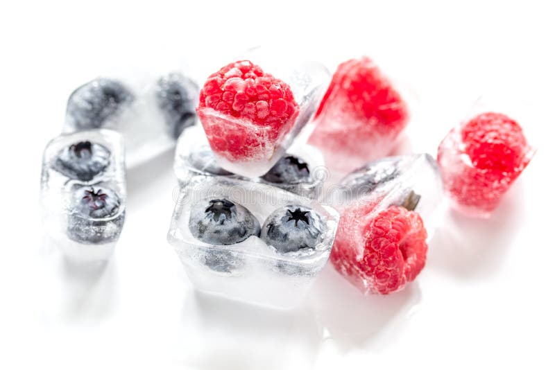 Frozen Blueberry and Raspberry in Ice Cubes on White Background Stock ...
