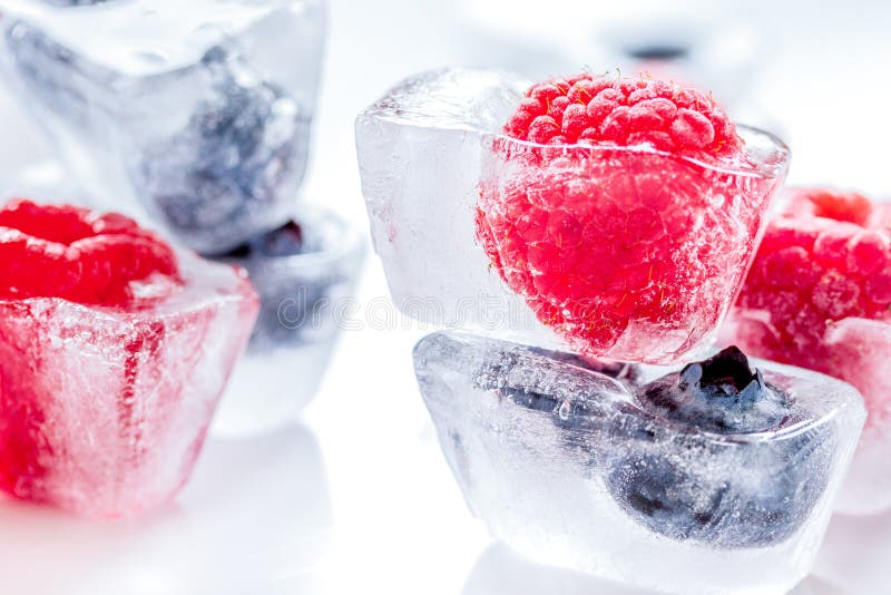 Frozen Blueberry and Raspberry in Ice Cubes on White Background Stock ...