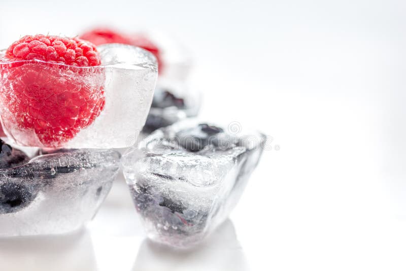 Frozen Blueberry and Raspberry in Ice Cubes on White Background Mock Up ...