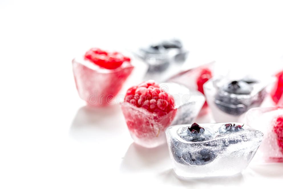 Frozen Blueberry and Raspberry in Icecubes on White Background Stock ...