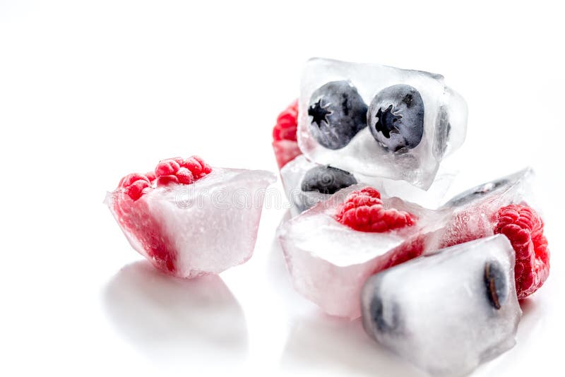 Frozen Blueberry and Raspberry in Icecubes on White Background Stock ...