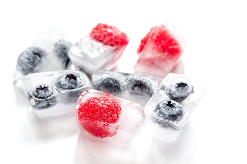 Frozen Blueberry and Raspberry in Icecubes on White Background Stock ...