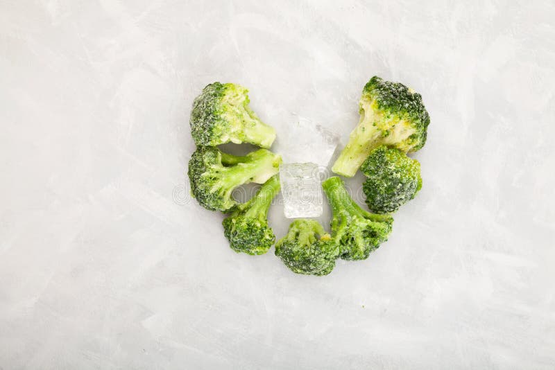 Frozen Broccoli and Ice Cubes on Kitchen Table. Freezing is a Safe ...