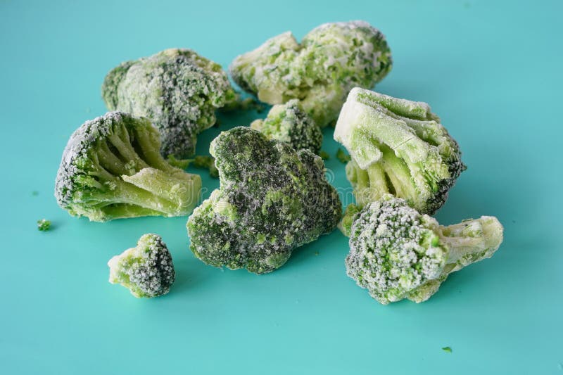 Frozen Broccoli Pieces Arranged on a Blue Background Stock Image ...
