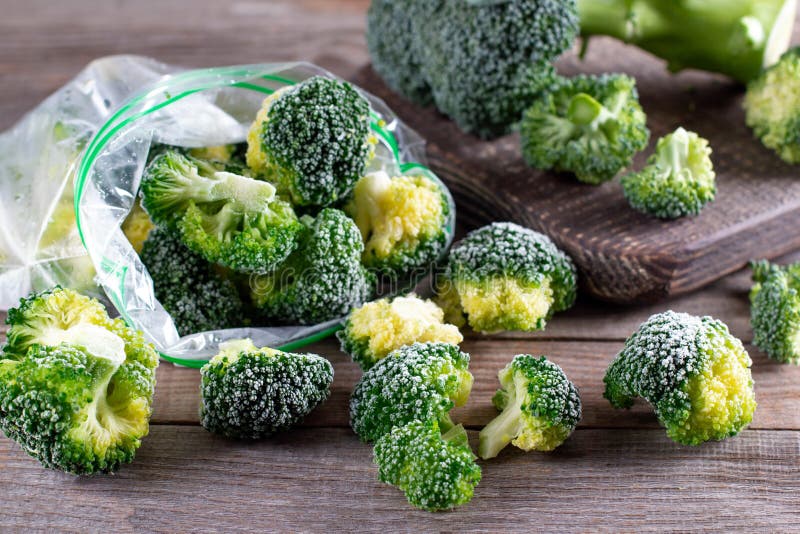 Frozen Broccoli in a Plastic Bag on Wooden Table. Selective Focus Stock ...