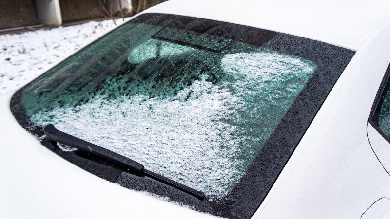 Frozen Car Windshield Covered with Ice and Snow on a Winter Day. Close ...