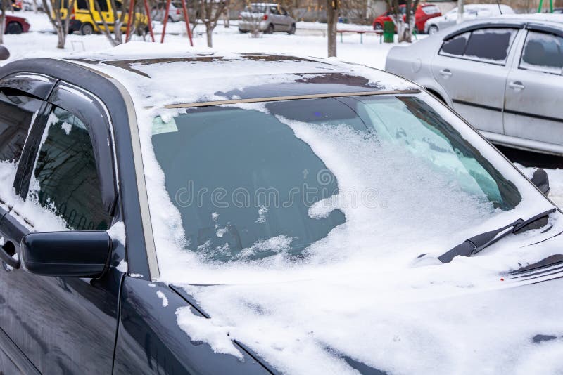 A Frozen Car Windshield is Covered in Ice and Snow on a Winter Day ...