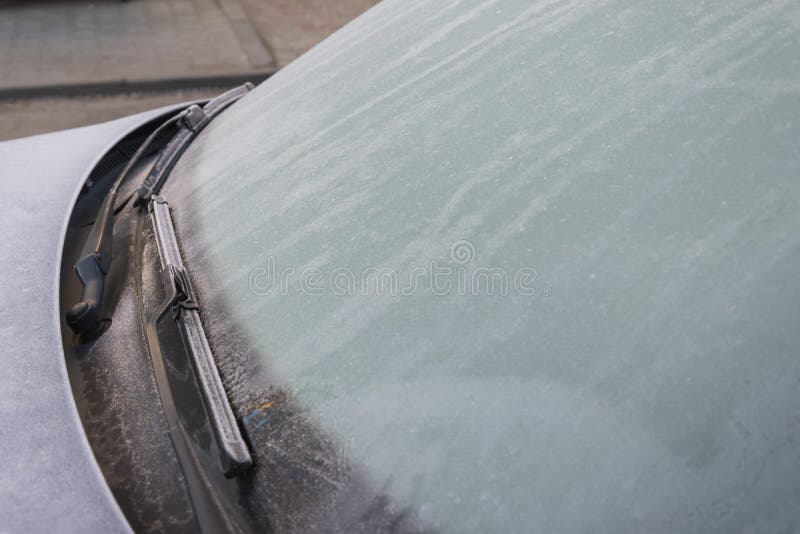 Frozen Car Windshield Covered with Ice and Snow on a Winter Day. Close ...