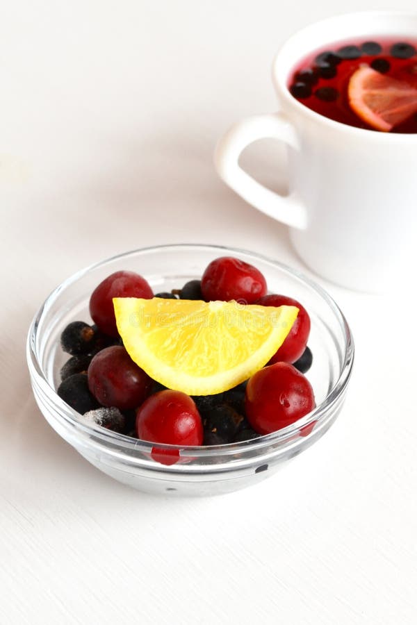 Frozen Cherries and Black Currants, a Slice of Fresh Lemon Stock Image ...
