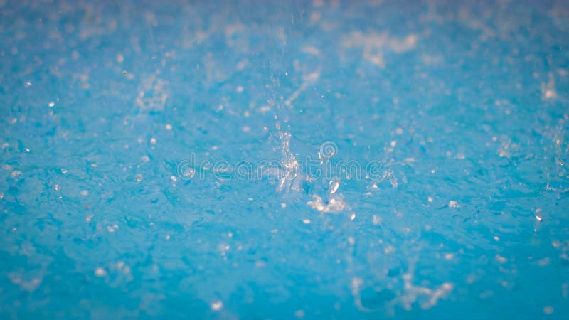 Frozen Droplets. Close Up of a Drop. Raining on a Blue Swimming Pool ...