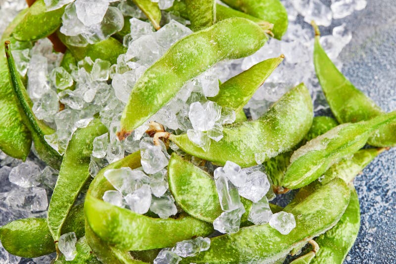 Frozen Edamame or Soybeans in the Mix with Crushed Ice on a Blue ...