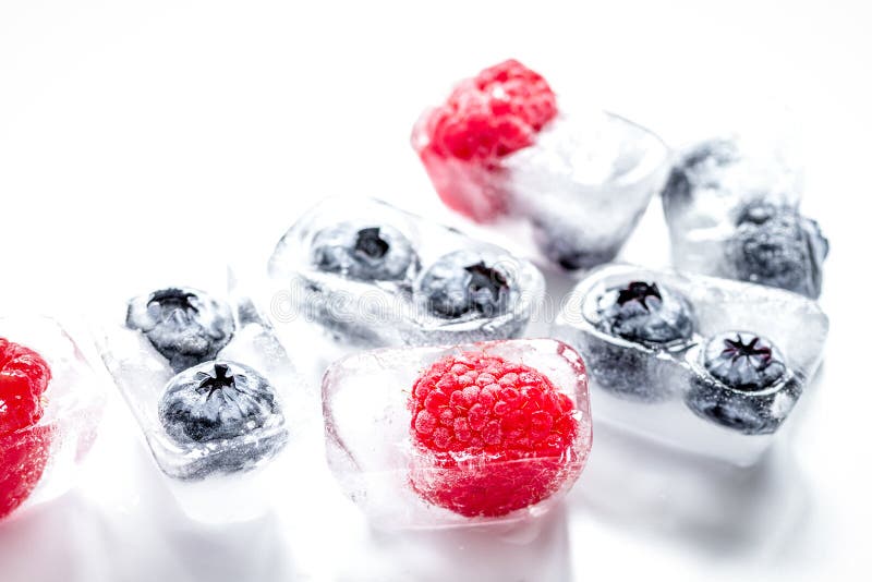 Frozen Blueberry and Raspberry in Ice Cubes on White Background Stock ...