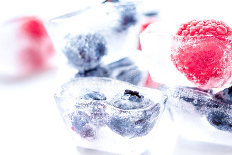 Frozen Blueberry and Raspberry in Ice Cubes on White Background Stock ...