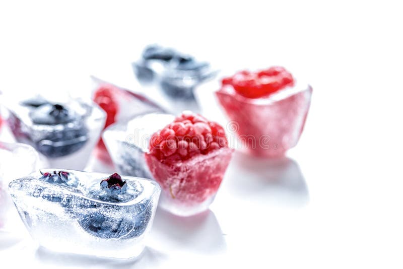 Frozen Blueberry and Raspberry in Icecubes on White Background Stock ...