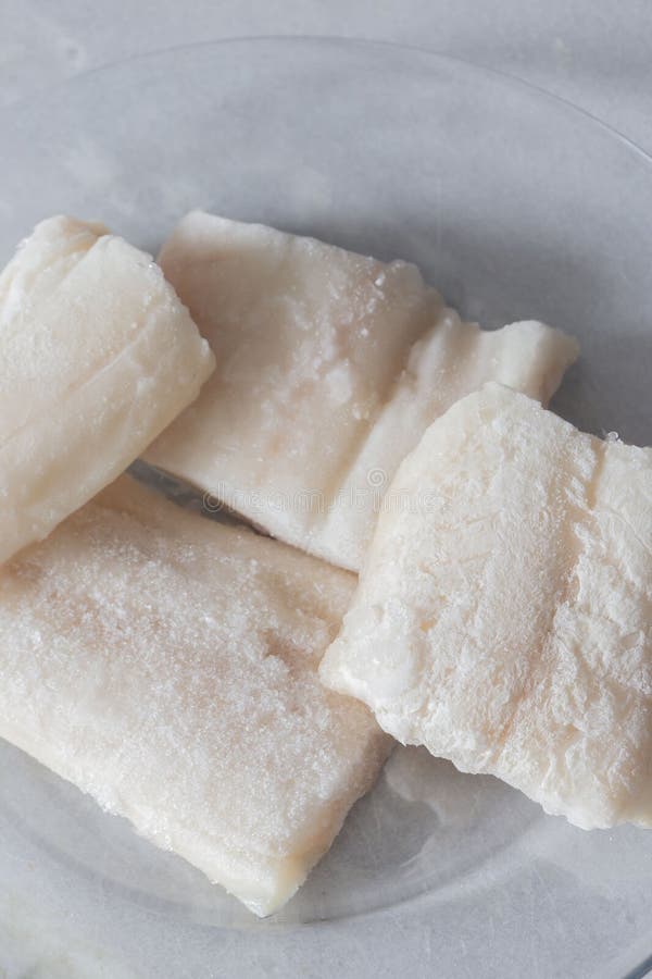 Frozen Haddock Fillets Defrosting on a Glass Plate. on a Granite ...