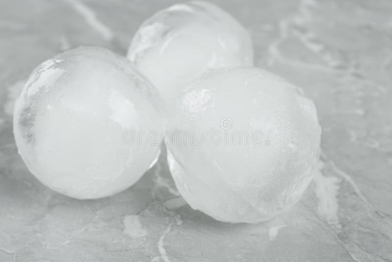 Frozen Ice Balls on Grey Marble Table, Closeup Stock Photo - Image of ...