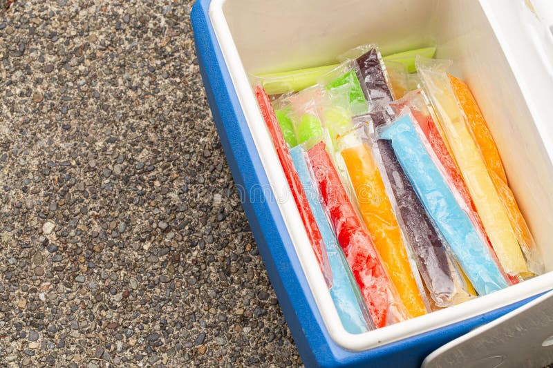 Frozen Ice Pop Popsciple in a Blue Cooler for a PIcnic Outside Stock ...