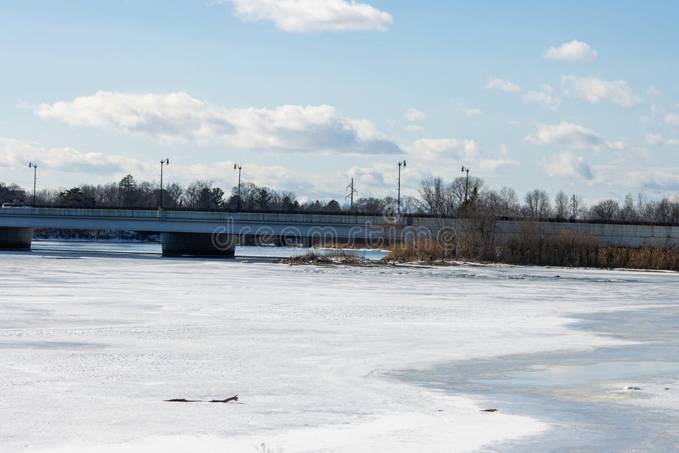 Frozen Ice on a River with a Bridge Stock Image - Image of beach ...