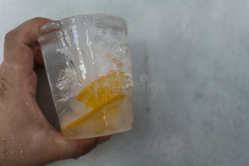 Frozen Ice with Slice Orange Fruit Inside Cup Shape from the Freezer on ...