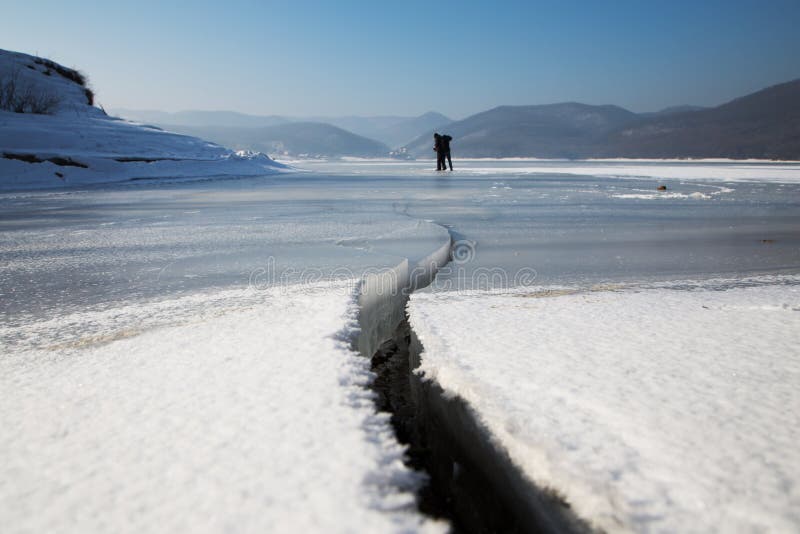 Cracked Frozen Lake With Mountain On Frozen Lake Baikal In Winter ...