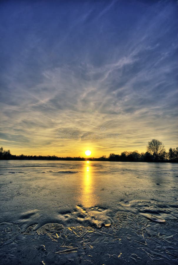 Sunset by a frozen lake stock photo. Image of nature, crack - 2032892