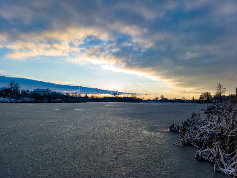 A Frozen Lake with a Sunset in the Background Stock Image - Image of ...