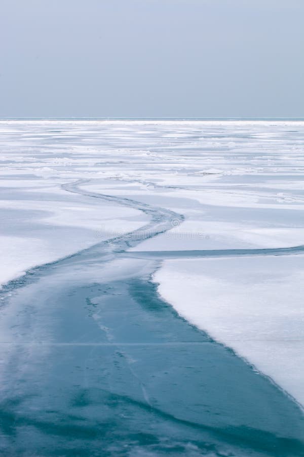 Frozen Lake Surface Covered in Snow with a Frozen Ice Path Stock Photo ...