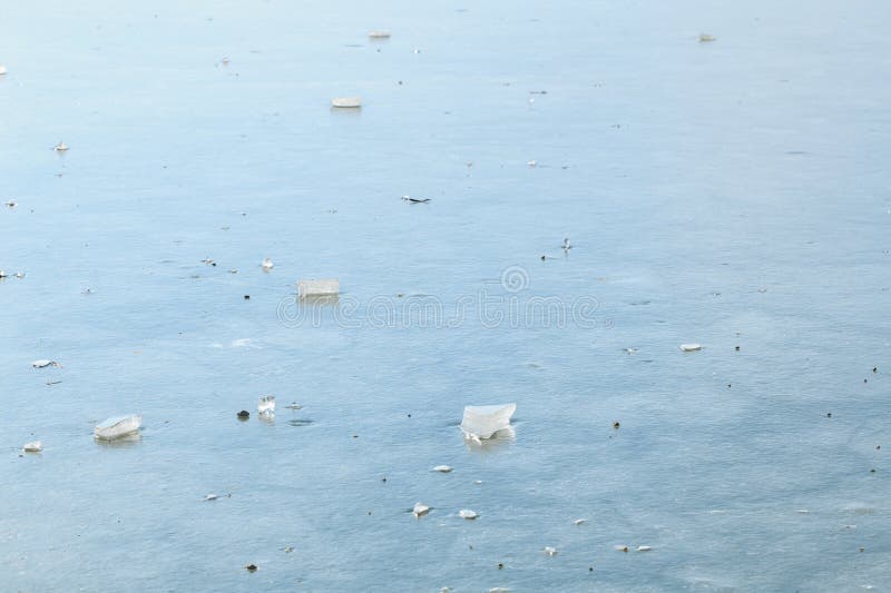 Frozen Lake Surface with Scattered Ice Chunks and Calm Reflection Stock ...