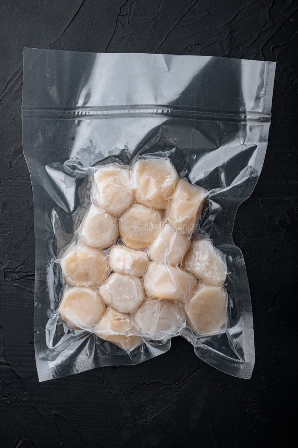 Frozen Meat Scallop in Vacuum Package, Flat Lay, on Black Textured ...