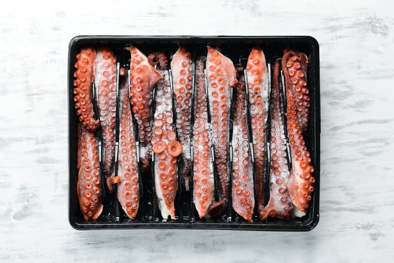 Frozen Octopus Tentacles in a Plastic Box. Stock Image - Image of ...