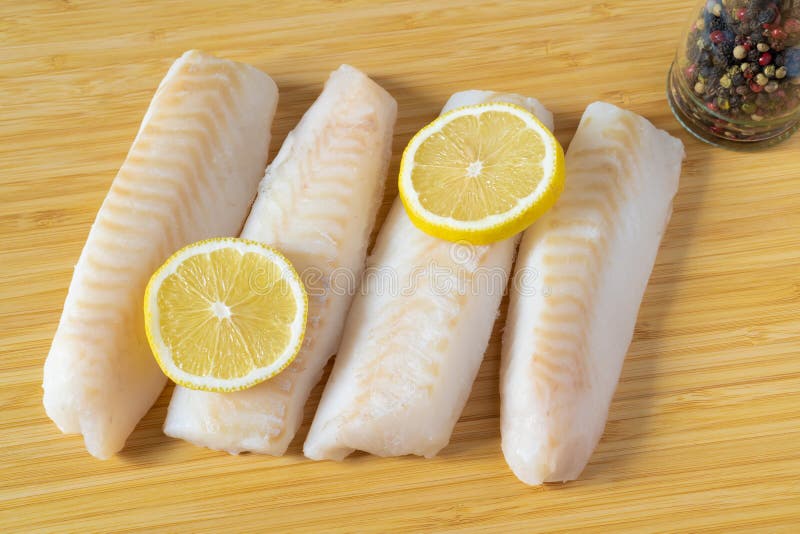 Frozen Pieces of Cod Fish Fillets or Loins with Slices of Lemon Stock ...
