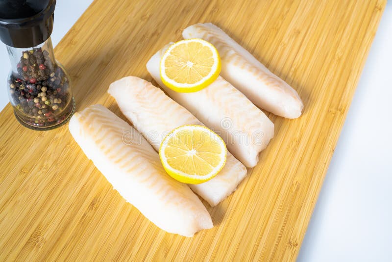 Frozen Pieces of Cod Fish Fillets or Loins with Slices of Lemon on ...