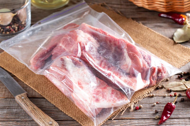Frozen Pork Meat in Plastic Package on a Table. Frozen Food Stock Image ...