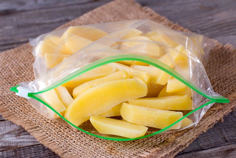Frozen Potatoes in a Bag on a Wooden Table. Frozen Food Stock Photo ...