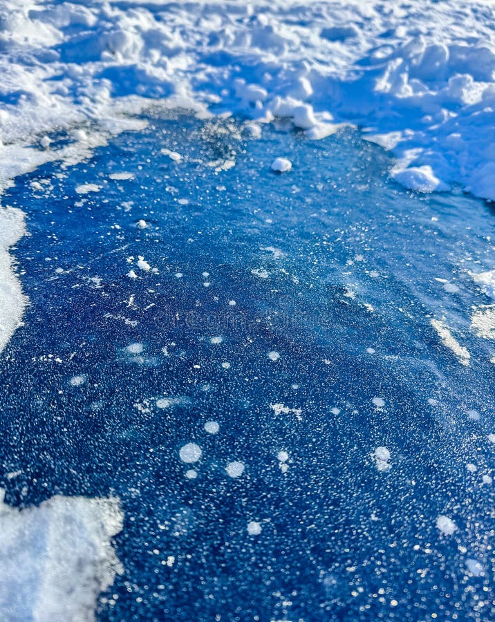 Frozen Puddle on a Snowy Surface, Ice Patterns and Trapped Air Bubbles ...