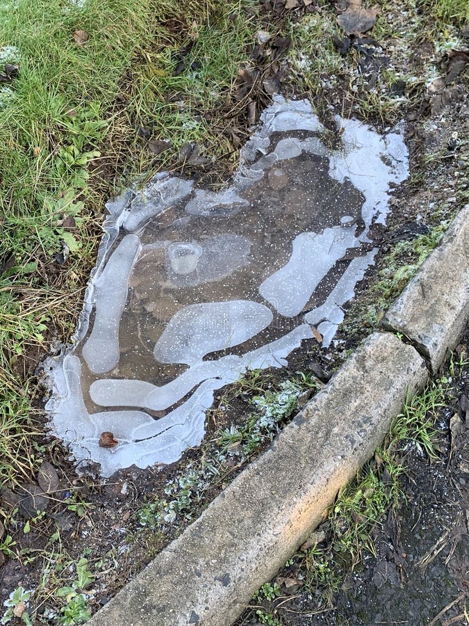 Frozen Puddle of Water on the Kerb Side Stock Photo - Image of water ...